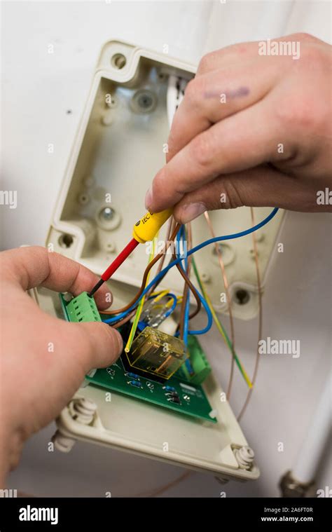 An Electrician Wiring In An Alarm Stock Photo Alamy