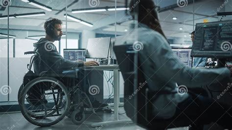 disability friendly office amazing it programmer with disability in a wheelchair working on
