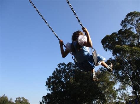 Premium Photo Rear View Of Girl Swinging At Park
