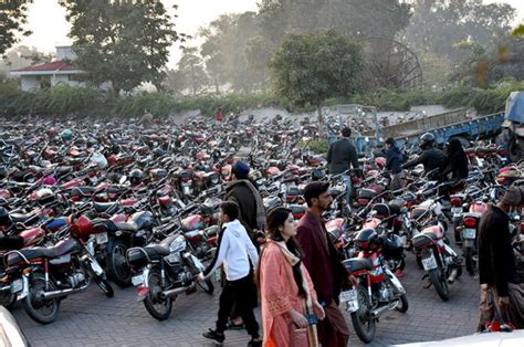 A View Of A Large Number Of Motorcycles Parked Outside Manto Park