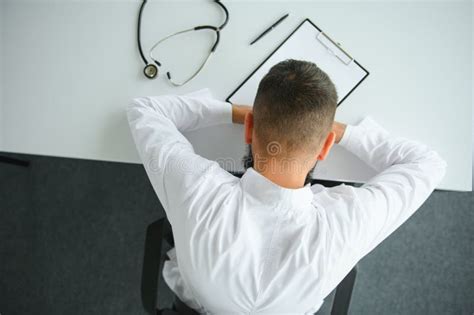 Portrait Of Exhausted Tired Young Arab Male Doctor After Hard Day At