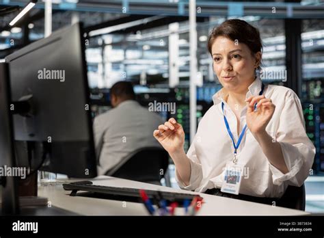 Data Center Technician Inspecting Gear Doing Maintenance Tasks