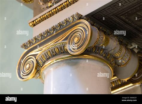 Decorative Features Of An Ionic Column Showcasing Intricate Gold