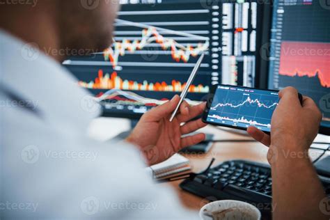 Many Graphs Holds Phone Young Businessman In Formal Clothes Is In