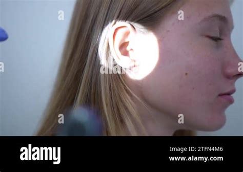 Close Up Side View Ear Of Female Teenage Patient With Rack Focus To