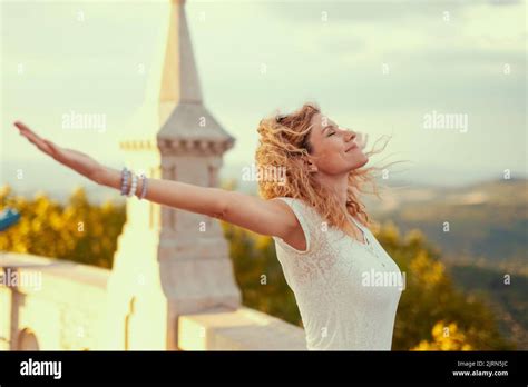 Young Carefree Caucasian Redhead Woman Spreading Arms Outdoors Stock