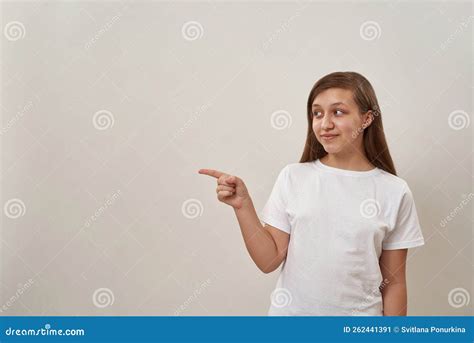 Teenage Girl Pointing With Finger And Looking Away Stock Image Image Of Smiling Female 262441391