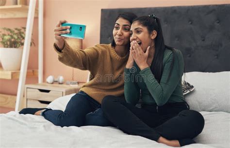 Selfie Social Media And Surprise With Sisters On Bed In Home Together