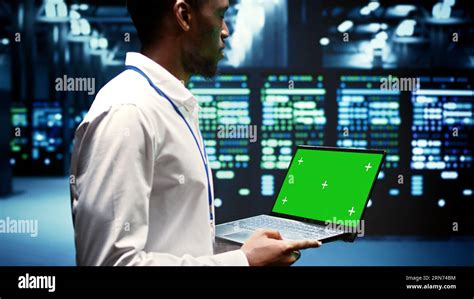 Developer Using Chroma Key Laptop To Do Checkup On High Bandwidth Dedicated Game Servers Used