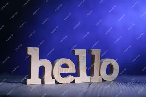 Premium Photo Hello Text Words Typography Written On Wooden Block Against Blue Background