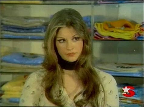 A Woman With Long Hair Standing In Front Of Shelves