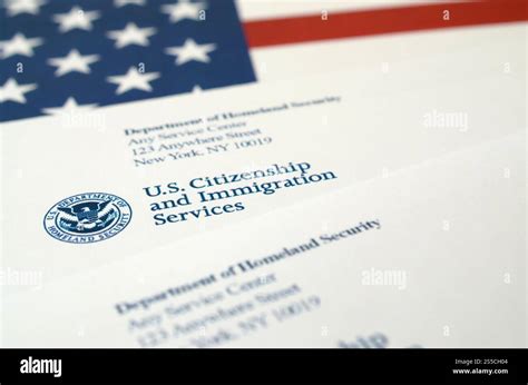 Envelopes With Letter From Uscis On United States Flag From Department
