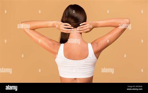 Back View Of Young Lady Self Massaging Her Neck Rubbing Skin While