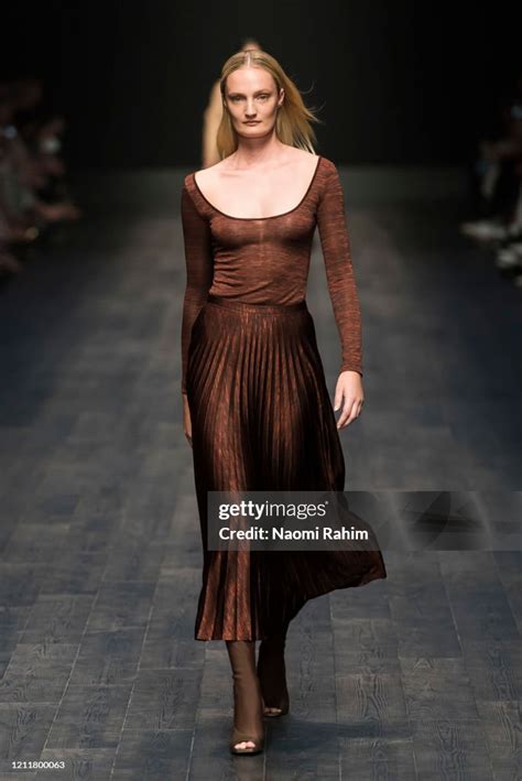 A Model Walks The Runway In Designs By Camilla And Marc During Runway