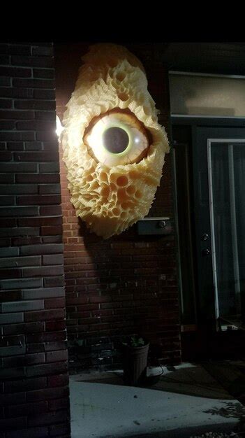 there is a fake eyeball hanging on the side of a building generative ai