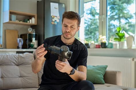Man Holding Massage Gun For Muscle Therapy Stock Image Image Of
