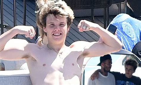 Cruz Beckham Playfully Flexes His Muscles Before Sharing A Sweet Hug