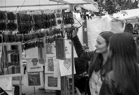Premium Photo Young Girl Choosing Sun Glasses At A Flea Market