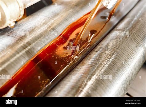 Precision Application Of Adhesive In Automated Glue Spreading Machine At Manufacturing Facility