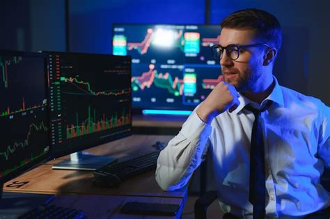 Premium Photo Businessman Comparing Stock Market Data Late In The Evening