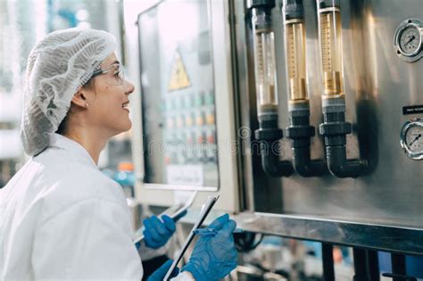 Worker In Drinking Water Plant Clean Hygiene Drink Factory Quality Control Monitoring Flow Meter