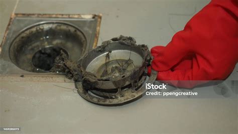 청소를 배수합니다 막히고 더러운 하수도 파이프 바닥 배수구 머리카락과 축적 된 막힌 기름으로 가득합니다 욕실에서 바닥 배수 하수 시스템을 유지 보수 깨끗한 세척을 고정하고