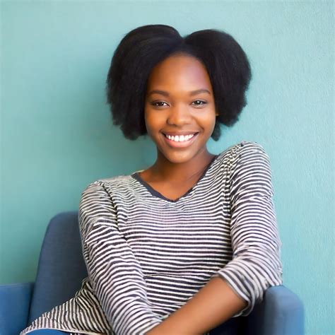 Premium Photo Portrait Of Black Woman Smiling On The Couch At Home