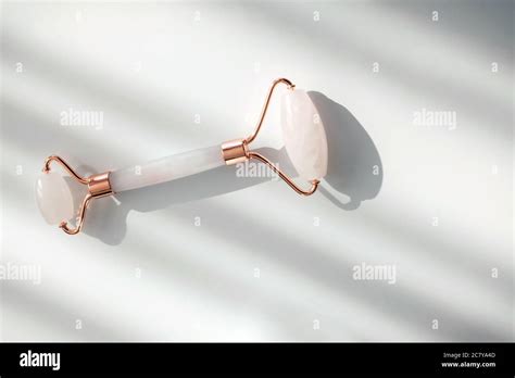 Facial Jade Massage Roller Or Gua Sha Over The White Background Stock