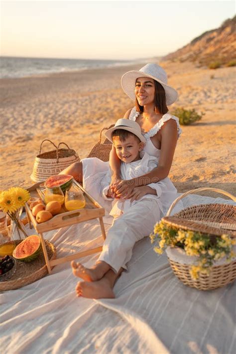 Mother And Son Enjoying A Sunny Beach Picnic Together Stock Photo Image Of Peaceful Seaside