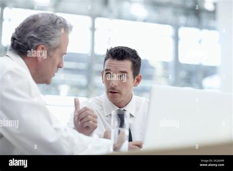we need to test the server two businessmen sharing a notebook in the