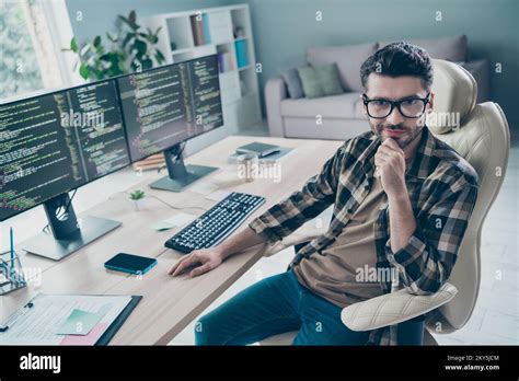 Photo Of Busy Smart Programmer Wear Spectacles Arm Hand Chin Testing