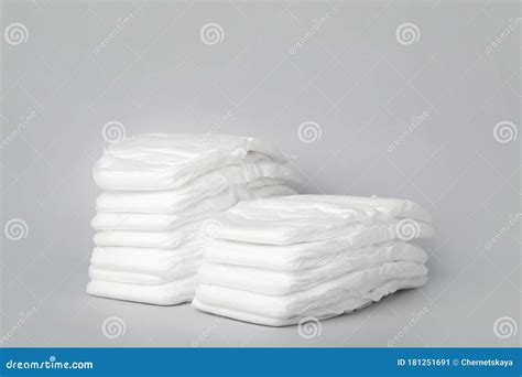 Stacks Of Diapers Stacked In Staggered Rows On A White Background