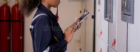 Electrical Young Asian Woman Engineer Examining Maintenance Cabinet System Electric And Using