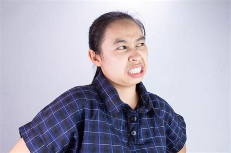 Premium Photo Woman Clenching Teeth Against White Background