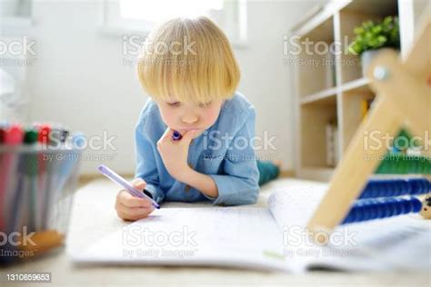 집에서 숙제를하고 초등학생 소년 어린이 학습은 계산 산술 예제를 해결 통합 책에서 운동을하고 수학 튜토리얼 학교를 위한 미취학 아동 아기를 준비합니다 교육 아이에 대한 스톡