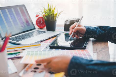 Graphic Designer Architects Who Work With Laptops And Color Comparison Tables For Design Work