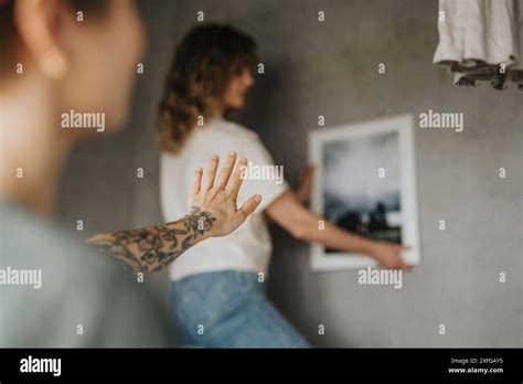 Tattooed Arm Of Lesbian Woman Giving Advice While Girlfriend Hanging
