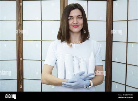 Master holds set of cosmetics - white bottles - Beautiful woman master ...