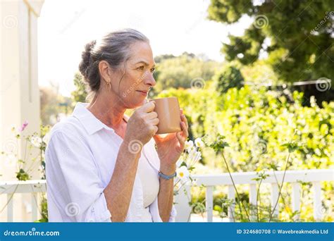 Mature Woman Drinking Coffee On Balcony Enjoying Peaceful Morning Outdoors Copy Space Stock