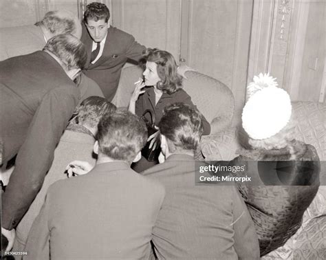 Actress Rita Hayworth In London Sitting On Couch Smoking A News