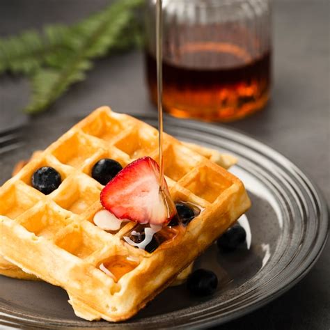 Free Photo Close Up View Of Pouring Maple Syrup On Waffle