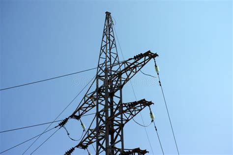 A Transmission Tower With Electrical Wires On It Against Blue Sky Stock Image Image Of Pillar