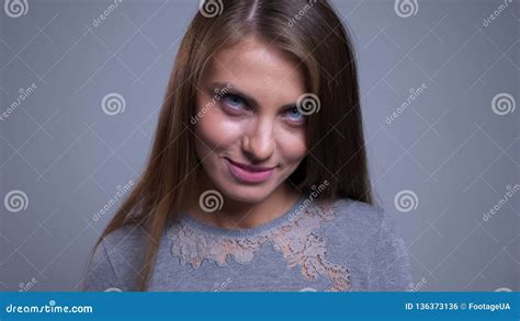 Closeup Portrait Of Seductive Young Caucasian Female Smiling Winking