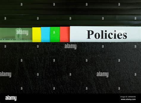 Hand Picking Policies File Record In Black Binder Folder Company And
