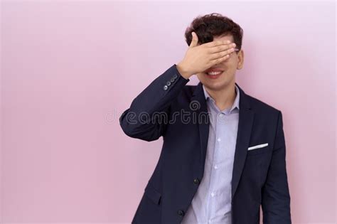 Young Non Binary Man With Beard Wearing Suit And Tie Smiling And