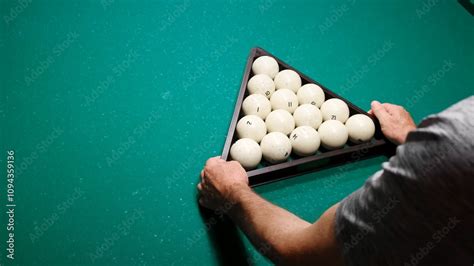 The Player Places The Triangle With Billiard Balls In The Designated Place On The Green Pool