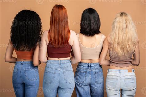 Rear View Four Diverse Women Standing Posing On Beige Background
