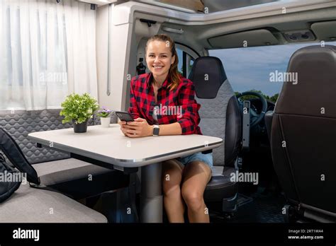 Young Adult Brunette Woman Wearing Plaid Shirt Sitting Inside The Motor