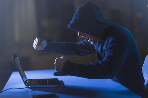 Premium Photo Angry Hacker With Laptop Shouting In Dark Room