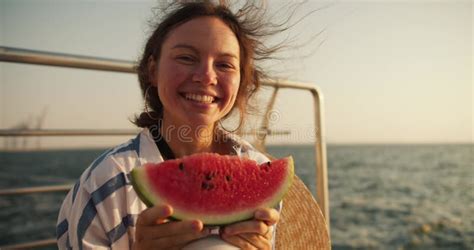 Portrait Of A Happy Girl Who Smiles And Looks At The Camera And Holds A